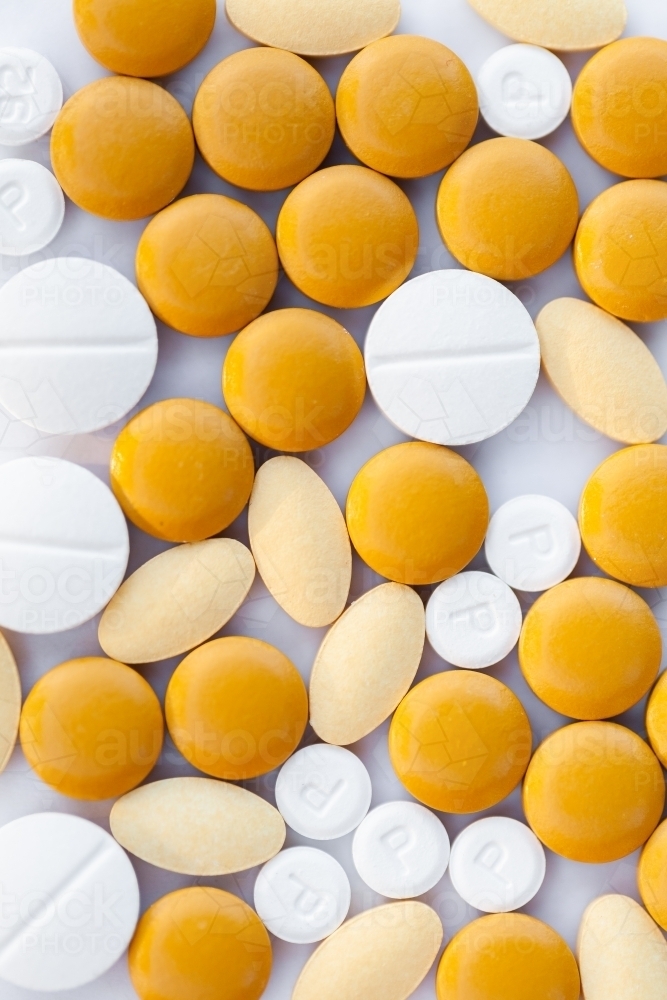 Image of Full frame medical tablets orange and white - Austockphoto