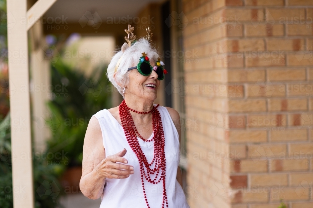 Image of fun-loving octogenarian having fun dressed up fancy for ...