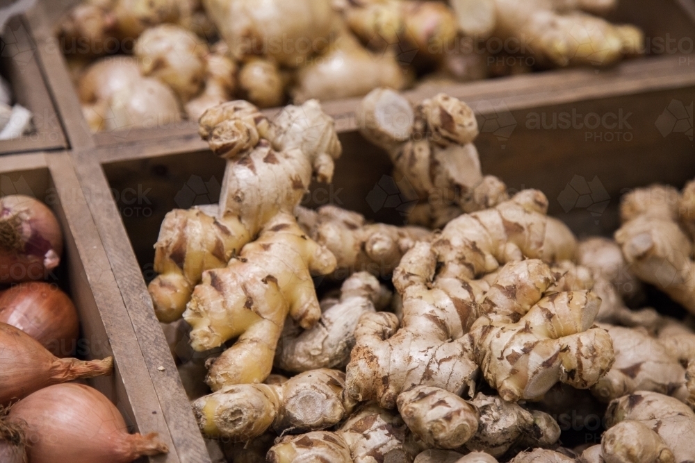 Image of Ginger in wooden box at market stall - Austockphoto