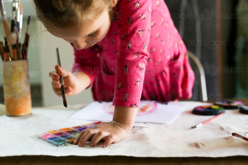 Image of Girl doing painting - Austockphoto