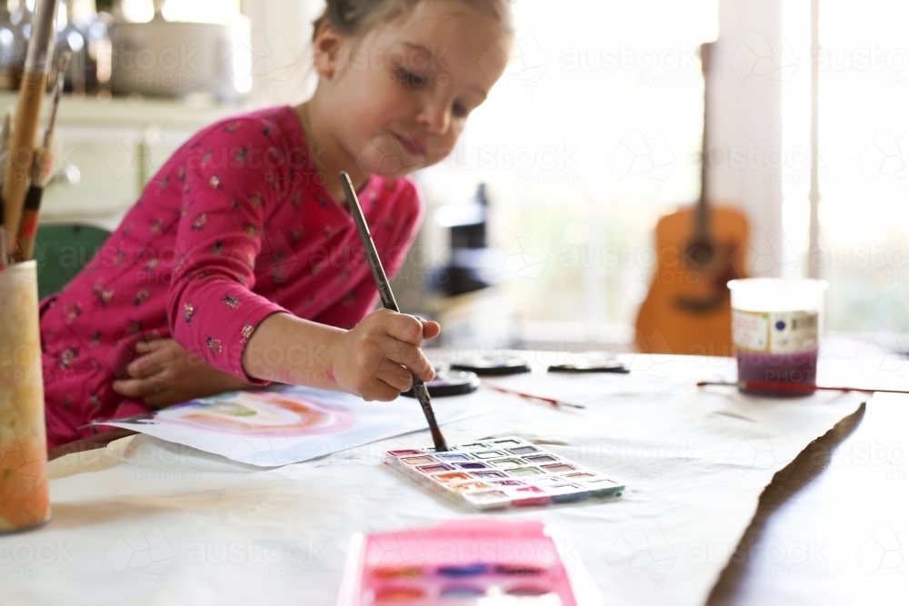 Image of Girl doing painting - Austockphoto