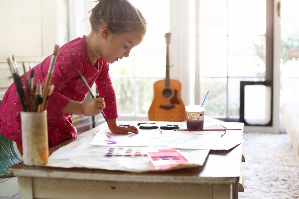 Image of Girl doing painting - Austockphoto