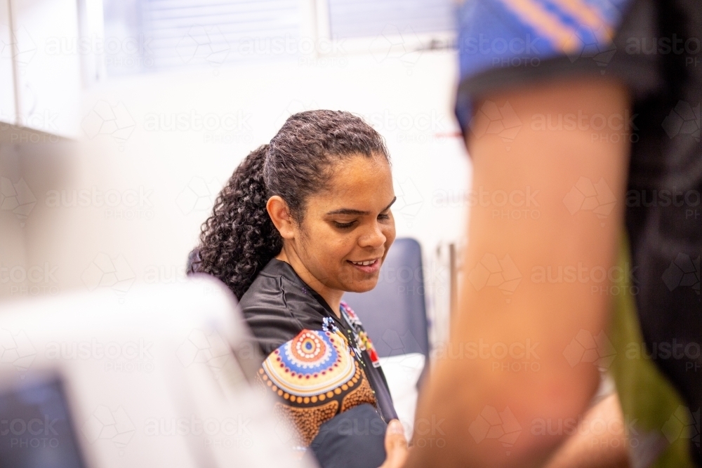 Image of Girl with curly hair seated with cuff on her arm - Austockphoto