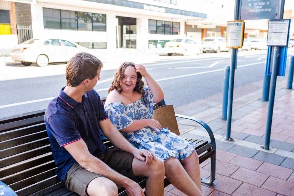Image of Girl with down syndrome chatting with disability worker at bus ...