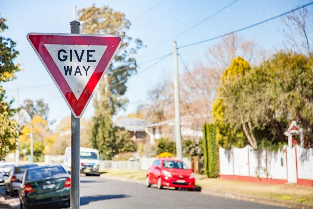 Image of Give Way road sign in urban setting with bright daylight ...
