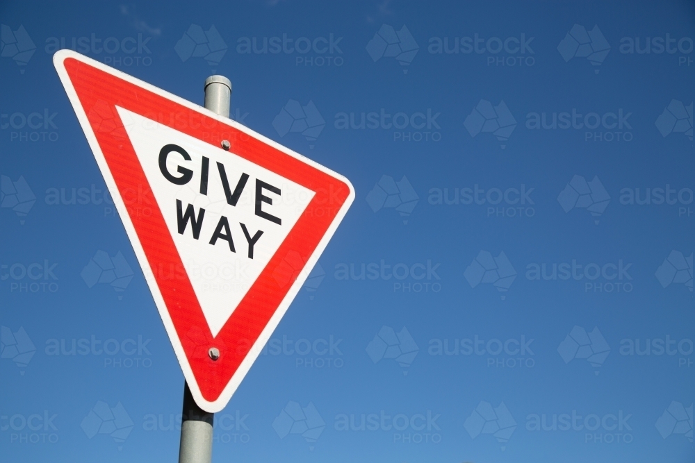 Image of Give Way sign and clear blue sky. - Austockphoto