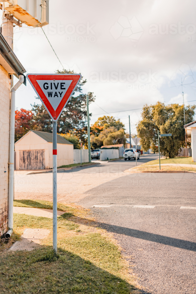Image of Give way sign at intersection in quiet small town - Austockphoto