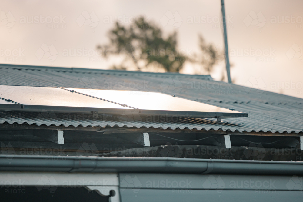 Image of Glare from sunlight hitting solar panels on roof of house ...
