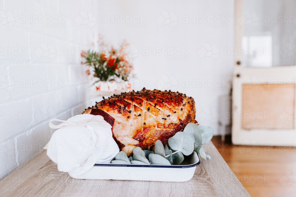 Image of Glazed and roasted holiday ham with cloves sitting on the ...