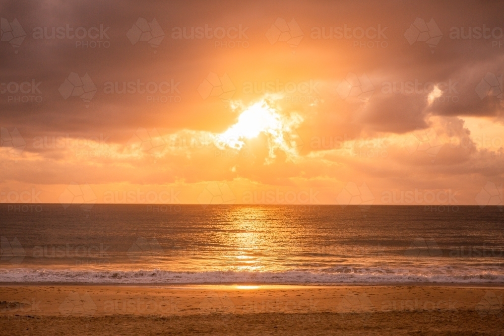 Image of Golden light at the beach at dawn - Austockphoto