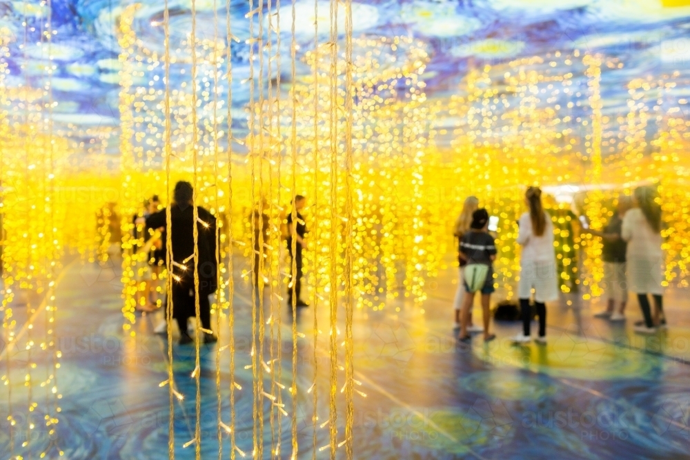 Image of Golden strings of fairy lights inside building with van gogh ...