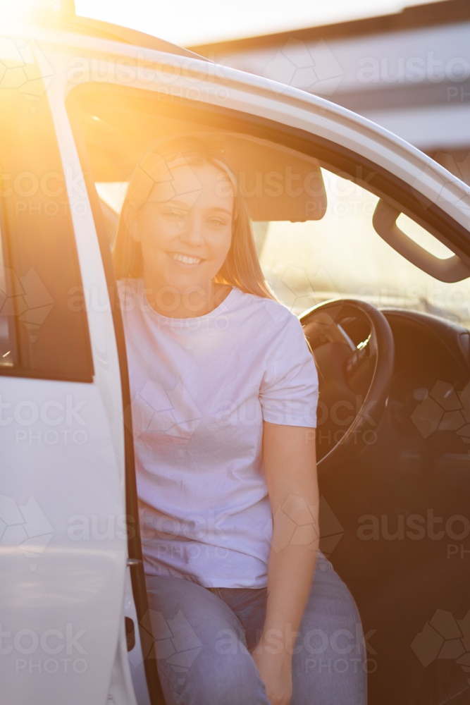 Image of golden sun flare over smiling aboriginal woman sitting in ...