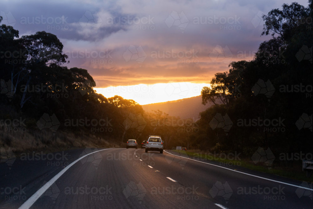 Image of Golden sunset haze in sky above dark road late in the day as ...