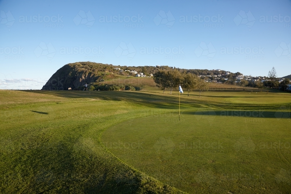 Image of Golf course green on headland - Austockphoto