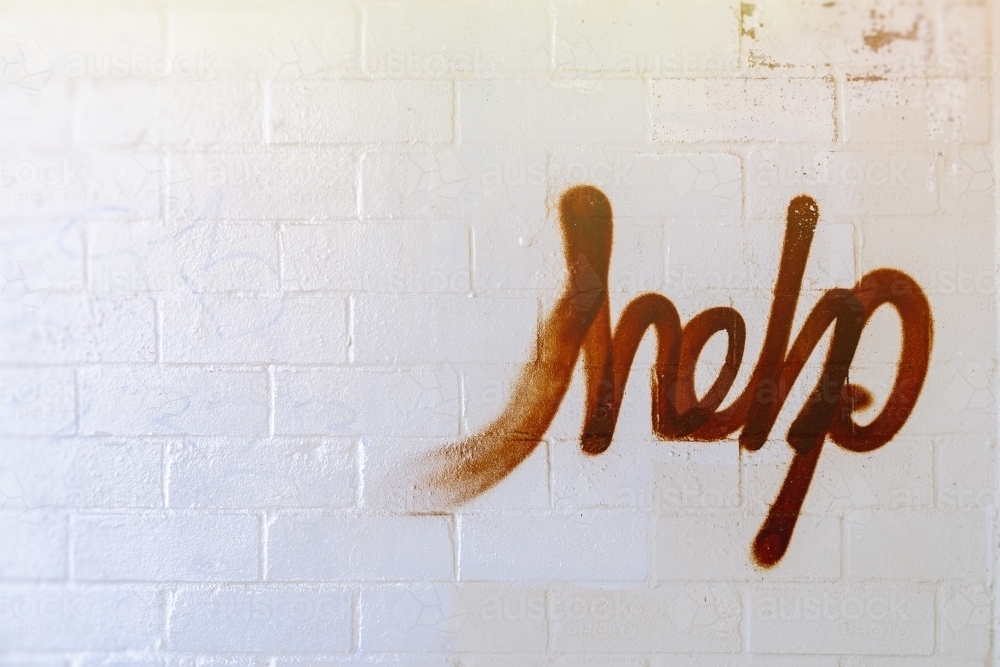 Image of Graffiti on white wall saying help - Austockphoto