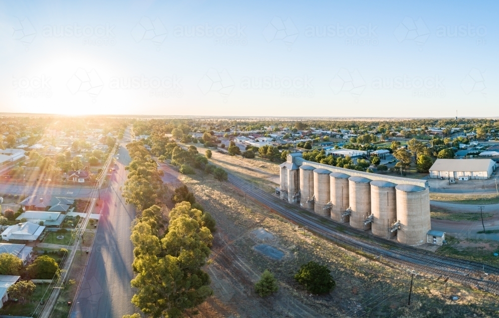 Image of Grain silos beside a railway track and road in a country town ...