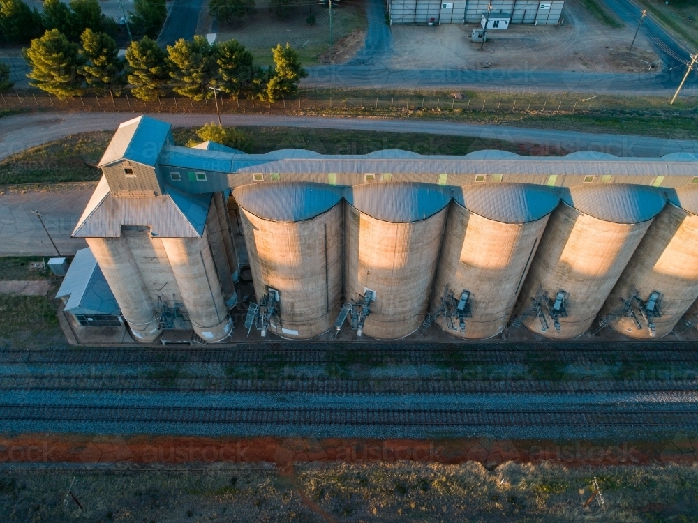 Image of Grain silos on a railway track in the country - Austockphoto