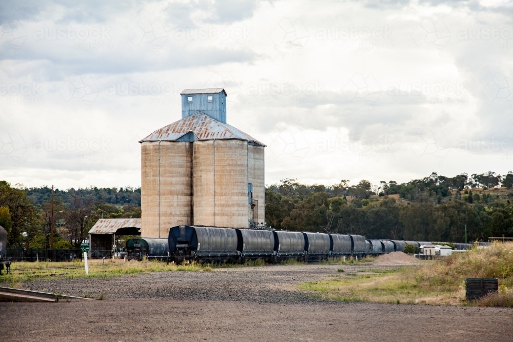 Image of Grain silos with train beside railway - Austockphoto