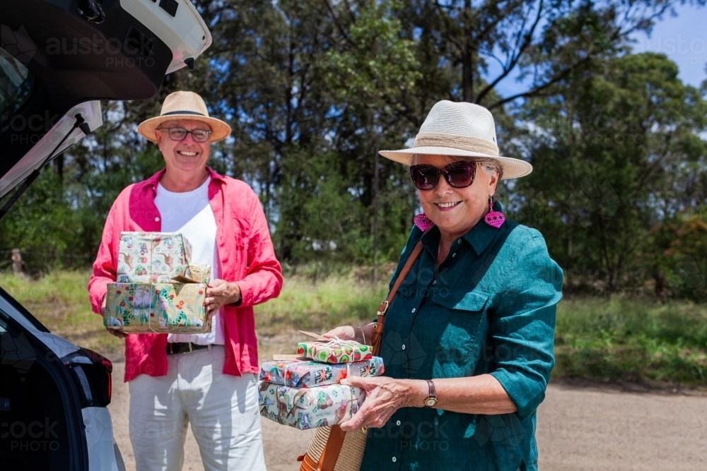 Image of Grandmother and grandfather unpacking piles of Christmas gifts ...