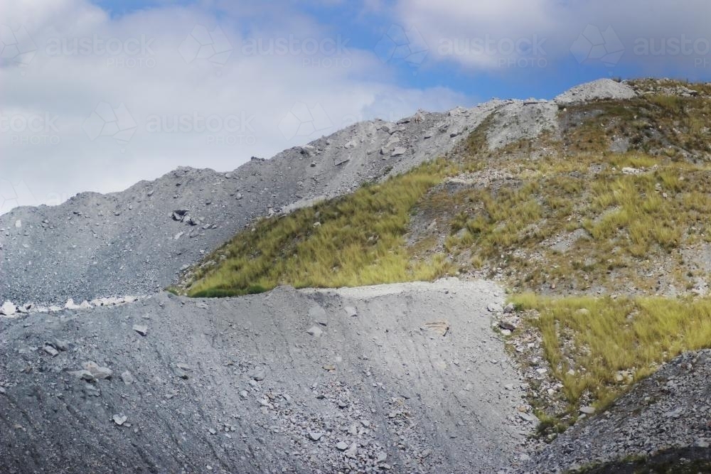 Image of Grass growing on piles of slag from a coal mine - Austockphoto