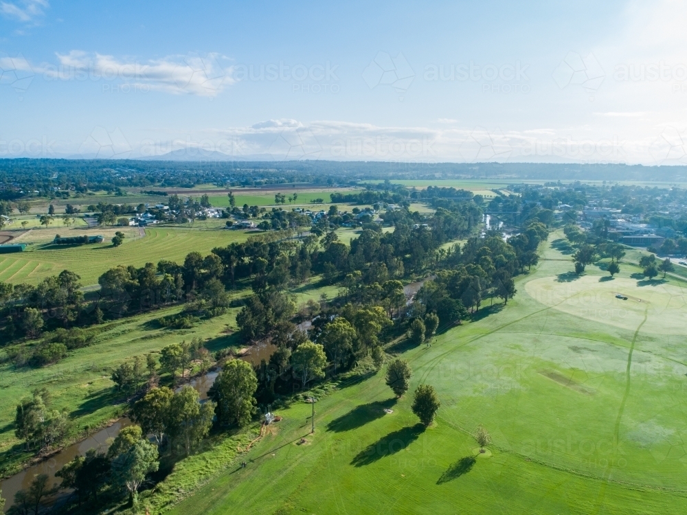 Image of Green sports ovals in morning light beside tree lined Hunter ...