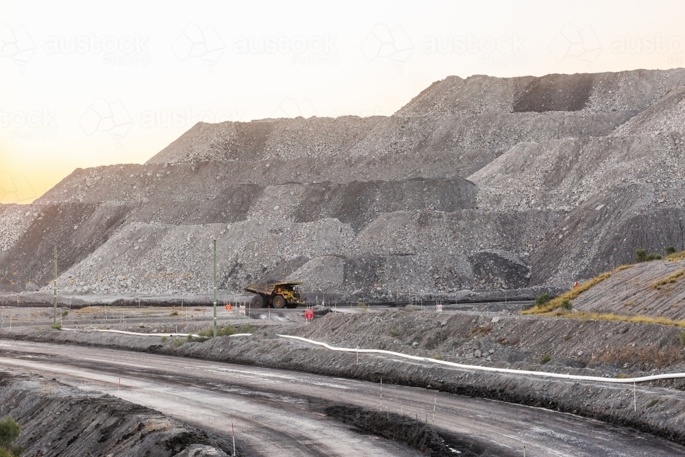 Image of Grey open cut mine hills with dump truck machinery working at ...
