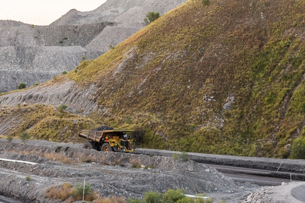 Image of Grey open cut mine hills with dump truck machinery working at ...