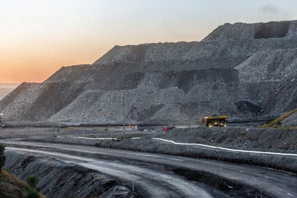 Image of Grey open cut mine hills with dump truck machinery working at ...