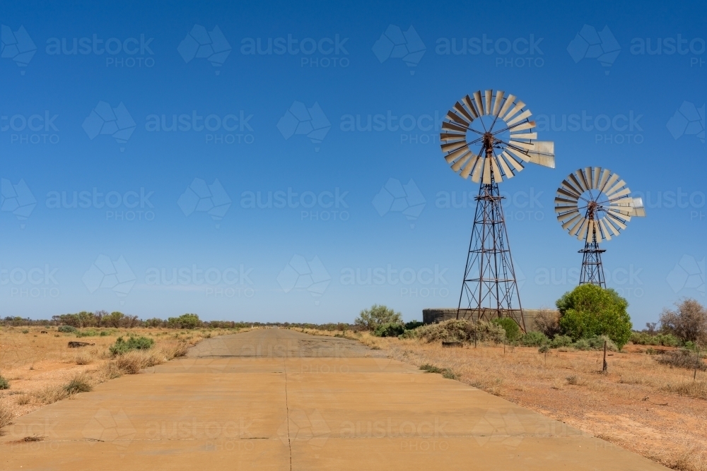 Image of Ground level view of a dusty outback road with two large ...