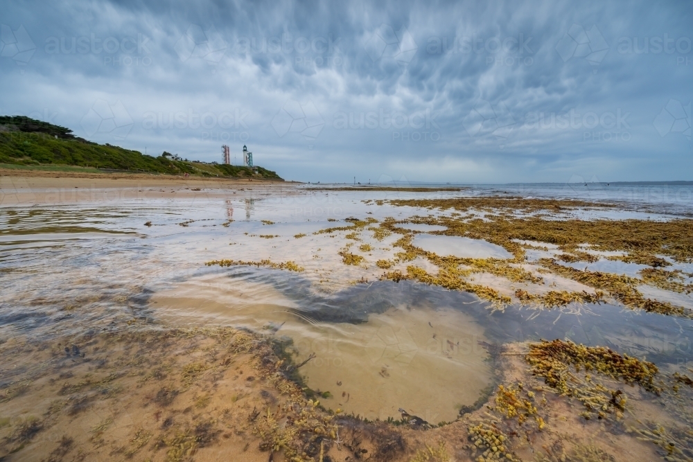 Image of Ground level view of a seawater covering rock pools under a ...