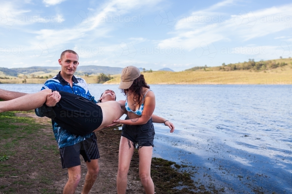 Image of Group of Aussie teens being silly together by the water on a summer afternoon ...