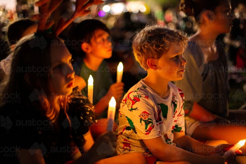 Image of Group of children at carols by candlelight event - Austockphoto