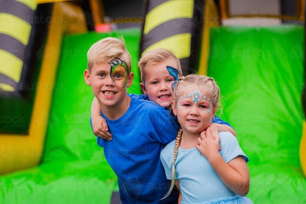 Image of Group of happy kids together at event with jumping castle in ...