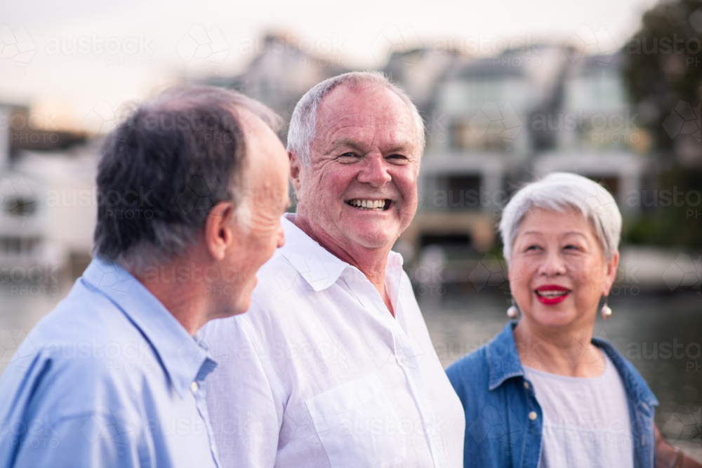 Image of group of happy seniors laughing in a coastal setting ...