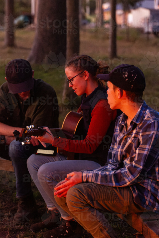 Image of group of siblings sitting around singing together at ...