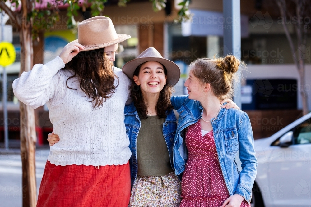 Image of Group of teen friends together downtown on windy day ...