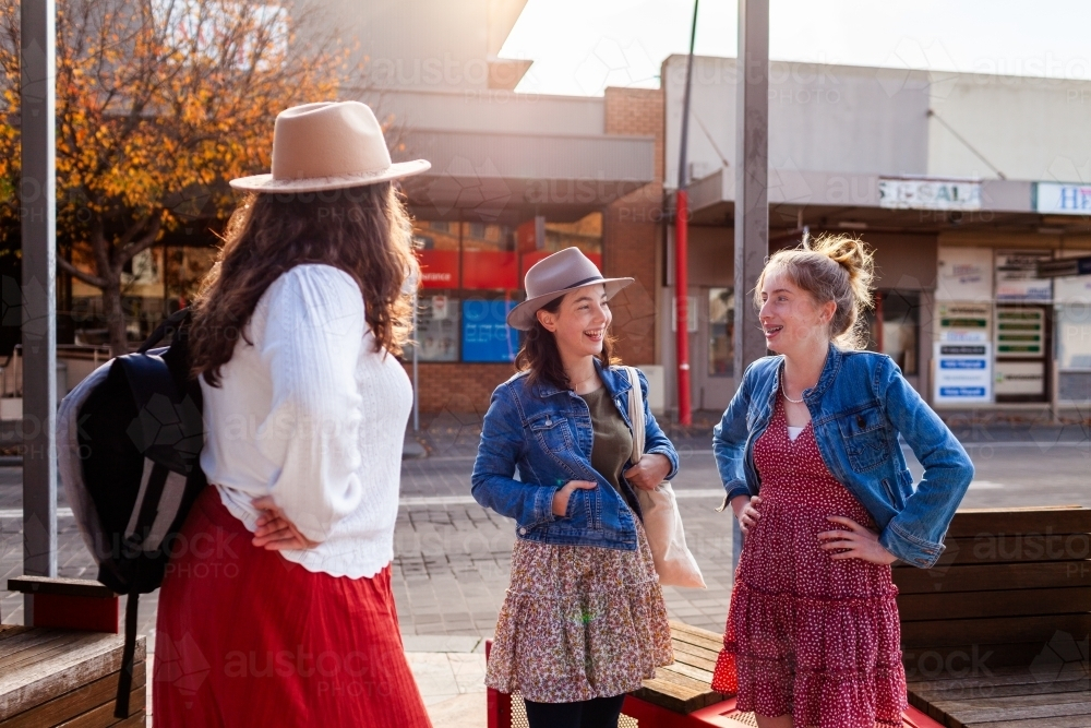 Image of Group of teen girls chatting together in urban setting in ...