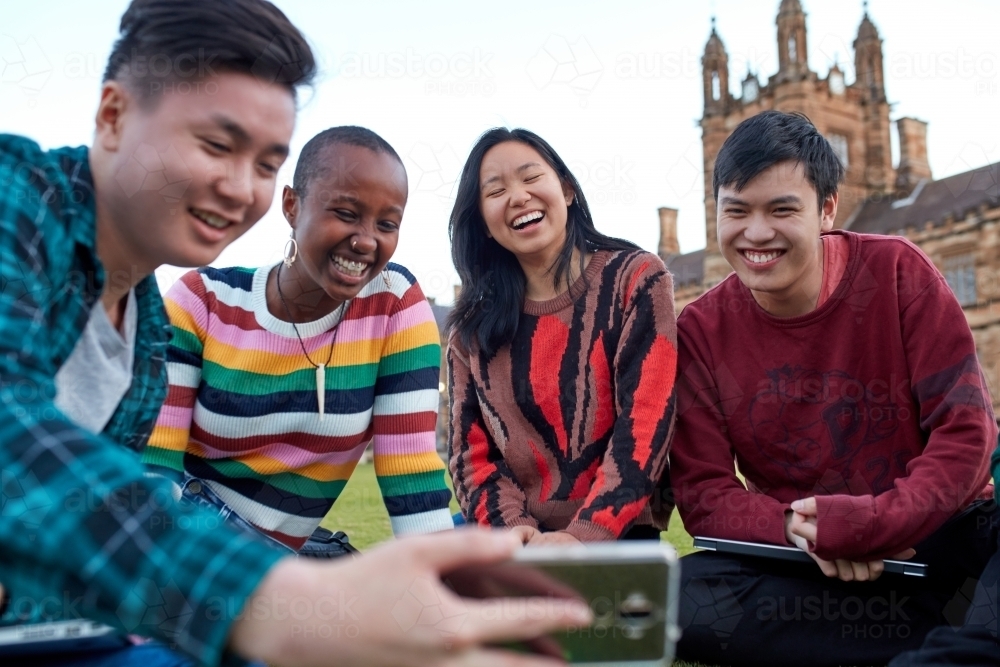 Image of Group of young university students hanging out sitting on ...
