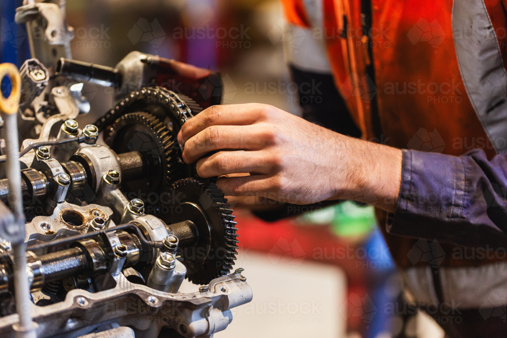 Image of Hand of a mechanic using a drill tool to pull apart and repair ...