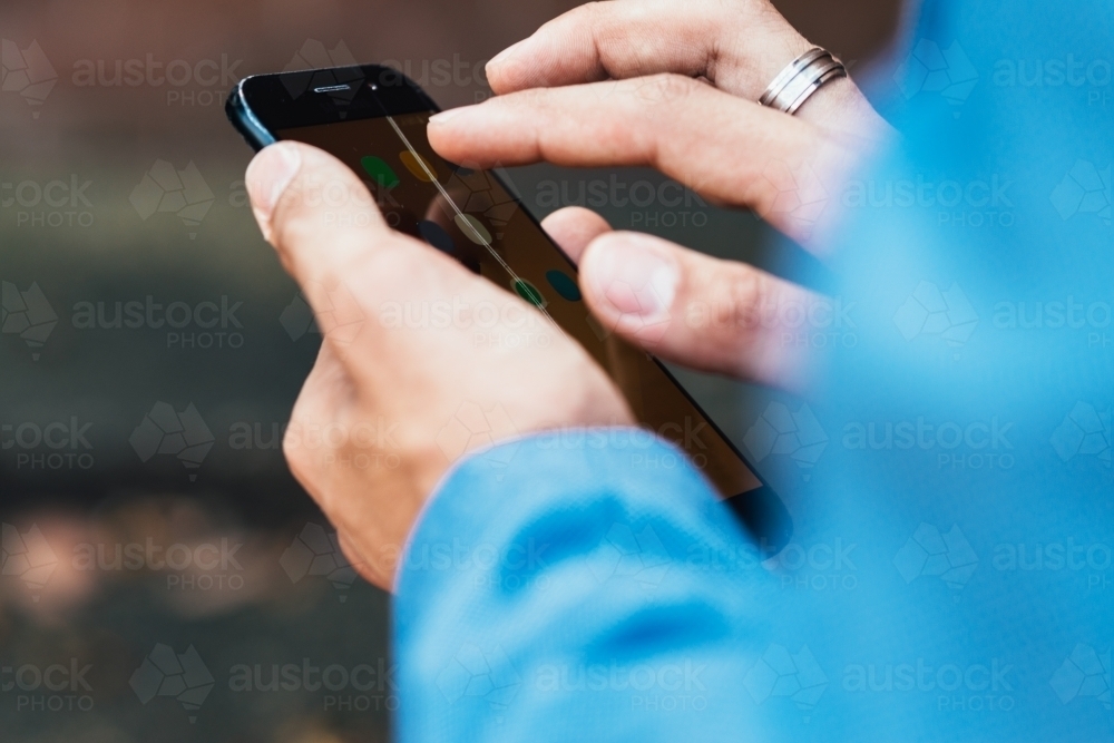 Image of hand on phone - Austockphoto