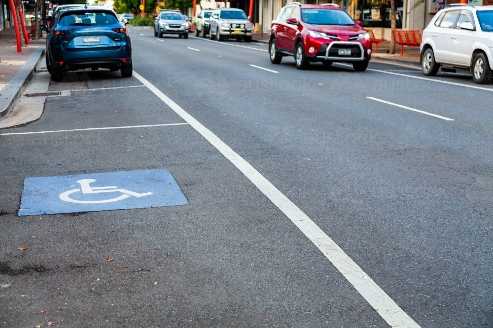 Image of Handicapped car parking space alongside road with traffic on ...