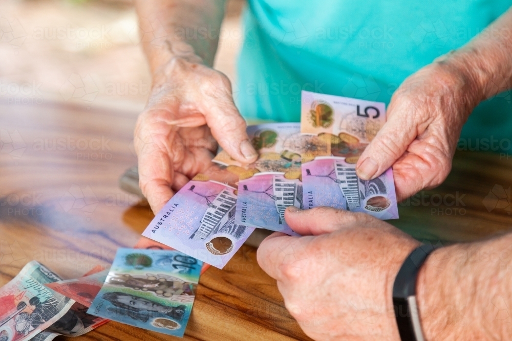Image of Hands of old person handing over money to a middle aged man ...