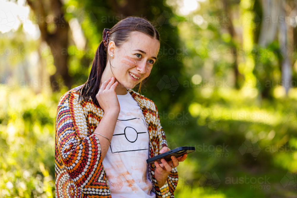Image of Happy Aboriginal teen girl using mobile phone device ...