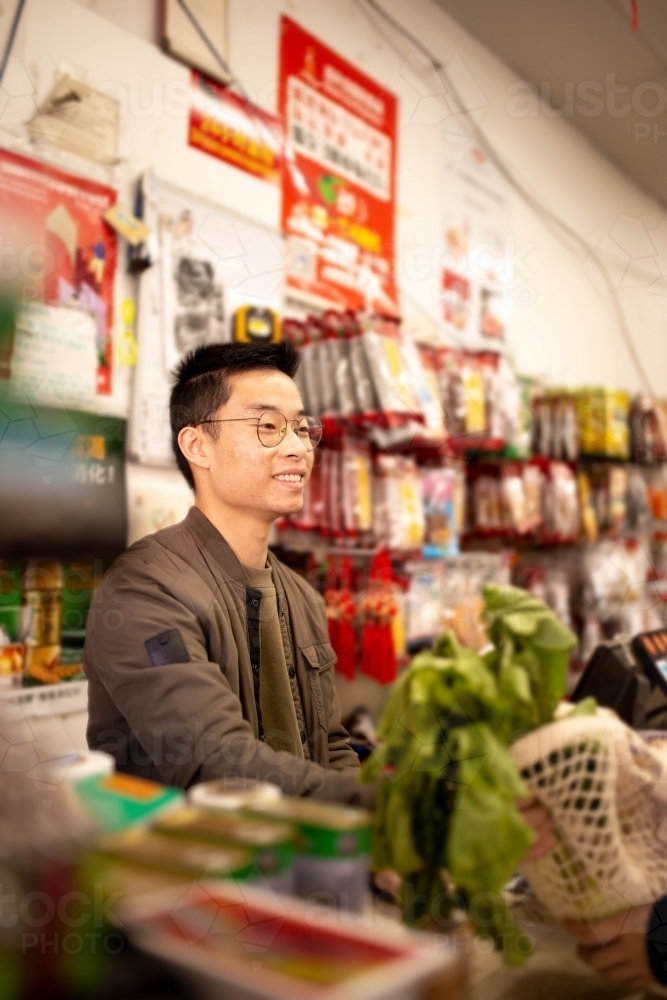 Image of Happy Asian grocery store manager in Ashfield working at the ...