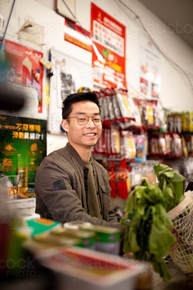 Image of Happy Asian grocery store manager in Ashfield working at the ...