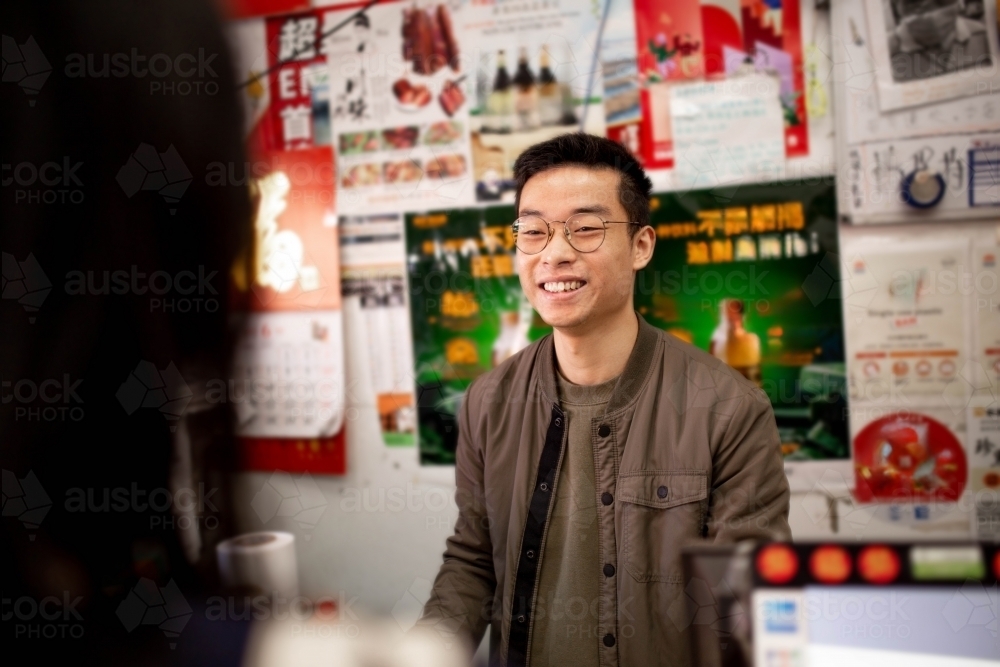 Image of Happy Asian grocery store manager in Ashfield working at the ...