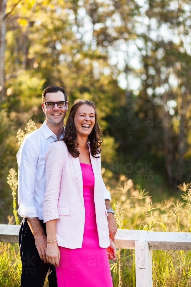 Image of Happy aussie couple standing together outside at park with ...