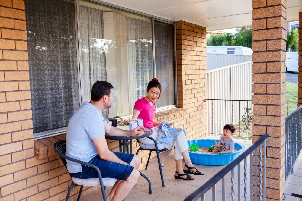 Image of Happy Australian couple relaxing on front porch drinking tea ...