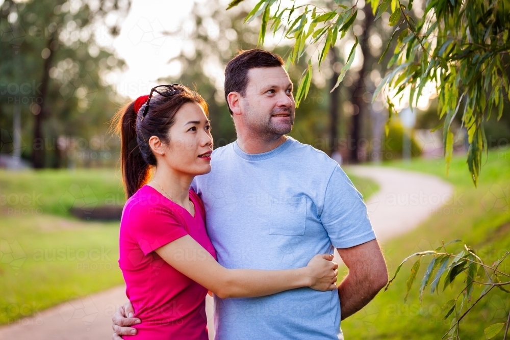 Image of Happy Australian couple standing together by path - Austockphoto