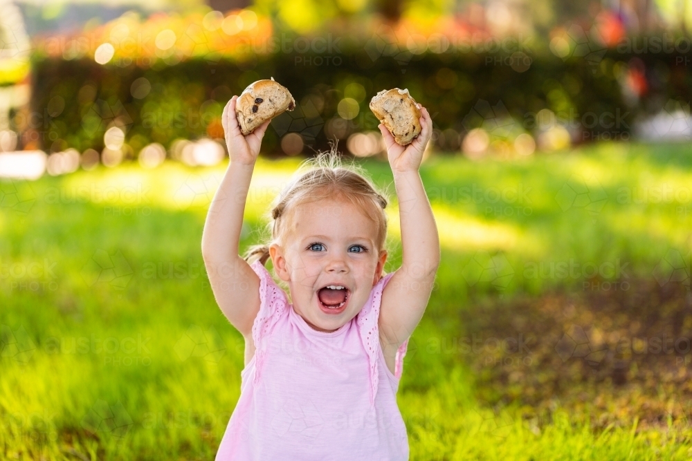 Image of Happy Australian kid with two hot cross buns at easter ...